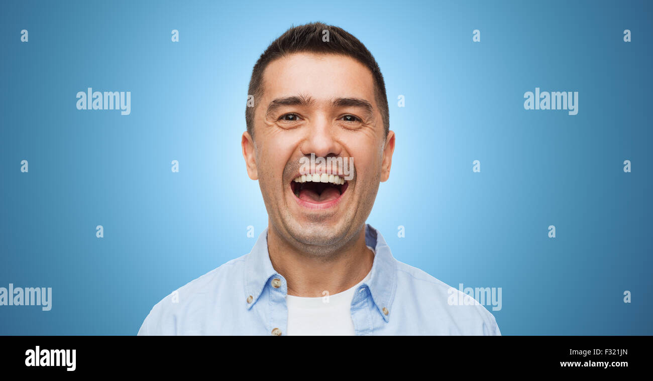 laughing man over blue background Stock Photo - Alamy