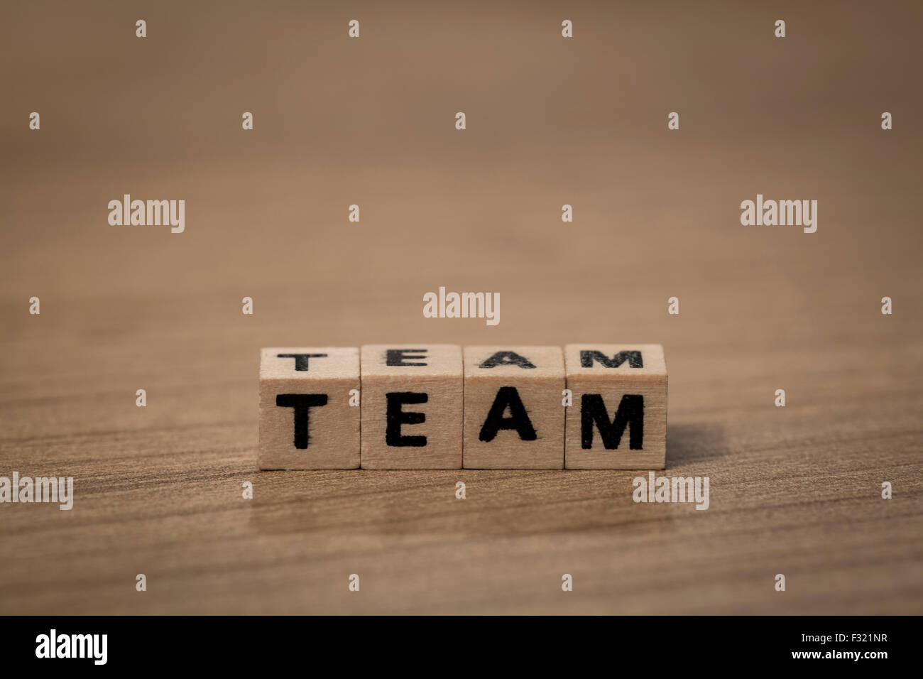 Team written in wooden cubes on a desk Stock Photo - Alamy