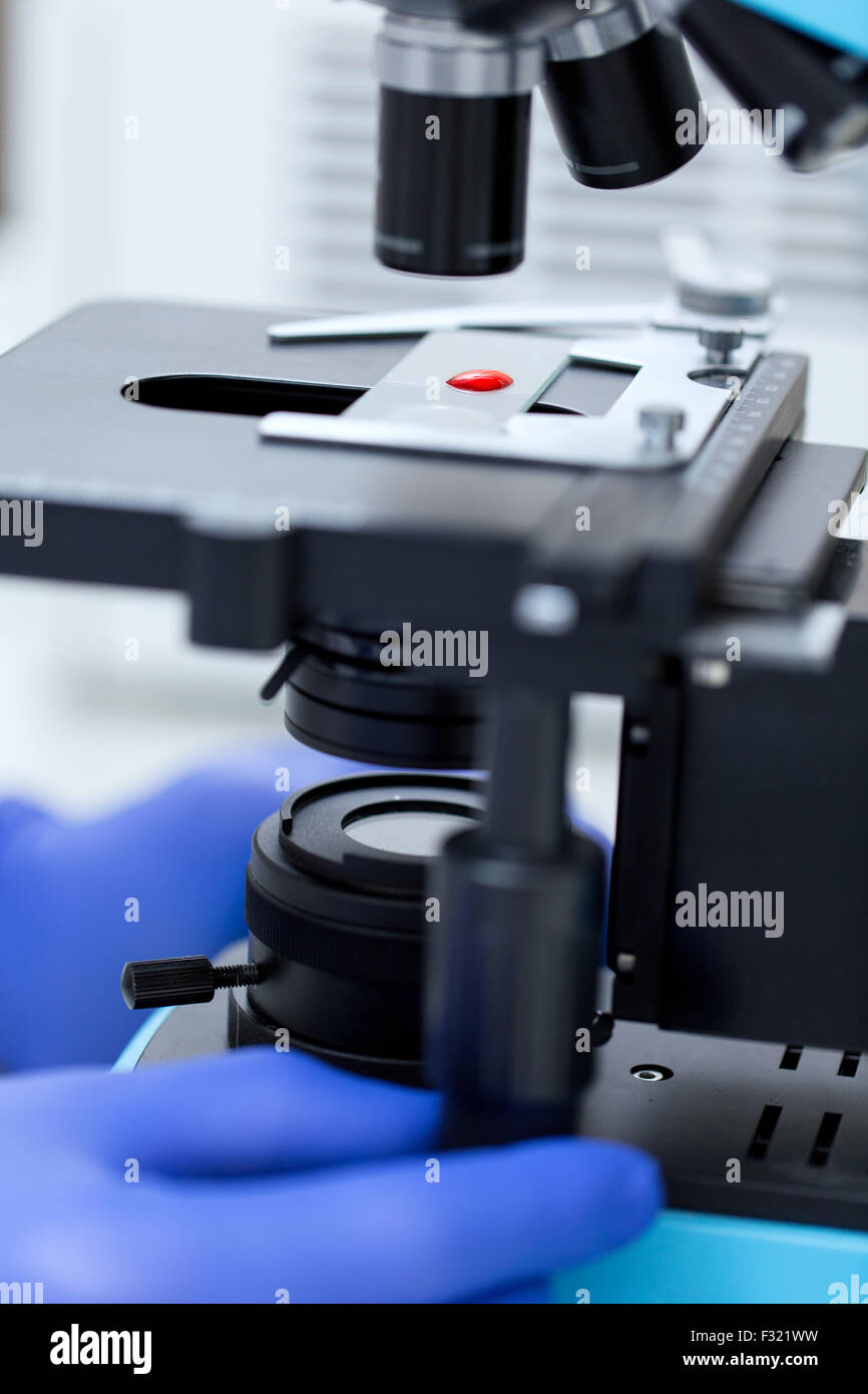 close up of hands with microscope and blood sample Stock Photo - Alamy