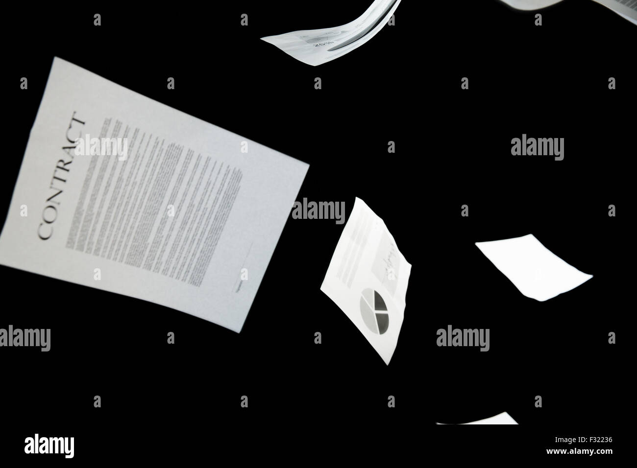 business papers falling down over black background Stock Photo - Alamy
