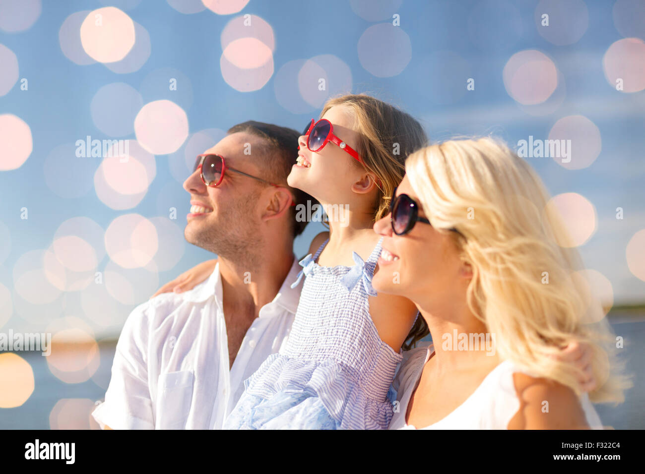 happy family over blue lights background Stock Photo - Alamy