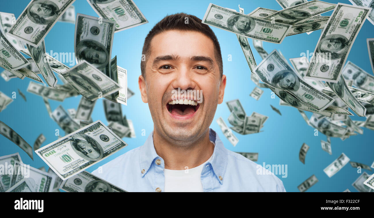 laughing man with falling dollar money Stock Photo - Alamy