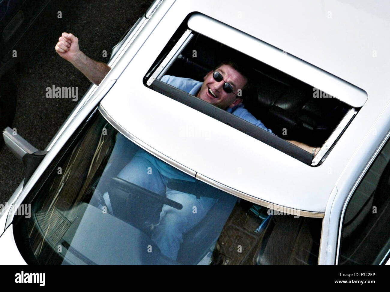 Elated man looking up through his car sunroof (credit image©Jack Ludlam ...
