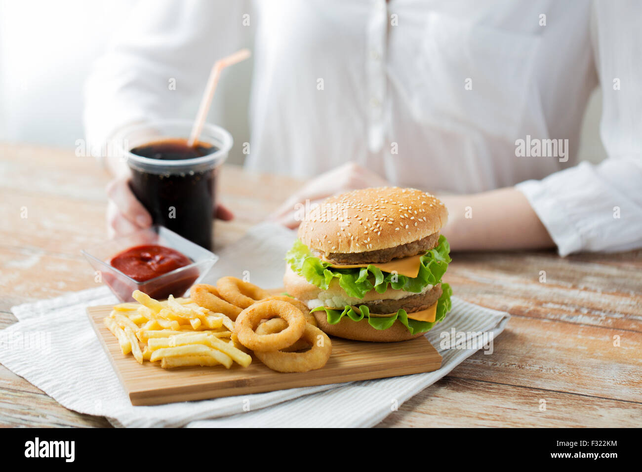 close up of woman with fast food and cola Stock Photo - Alamy