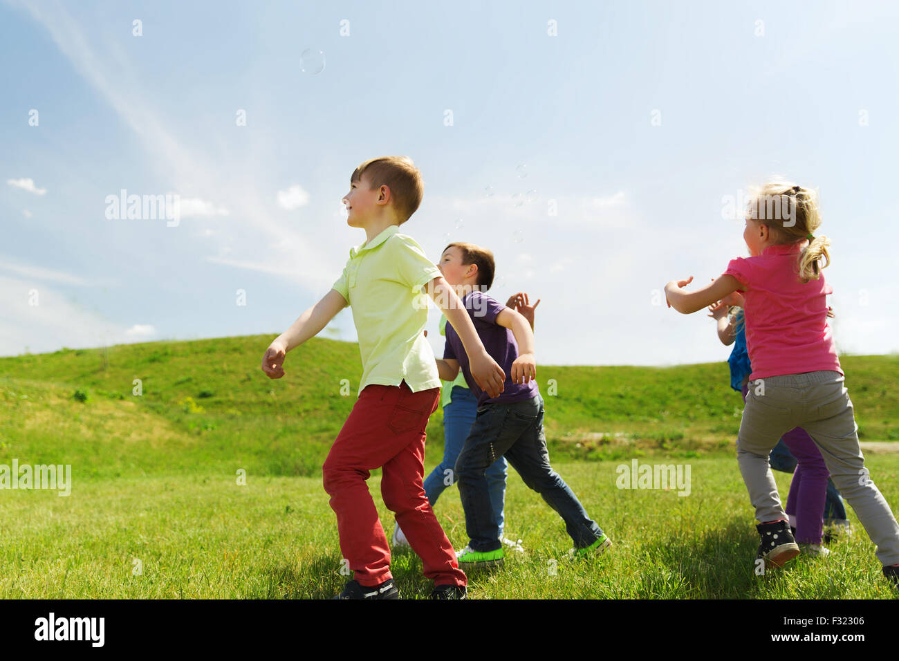group of happy kids running outdoors Stock Photo - Alamy