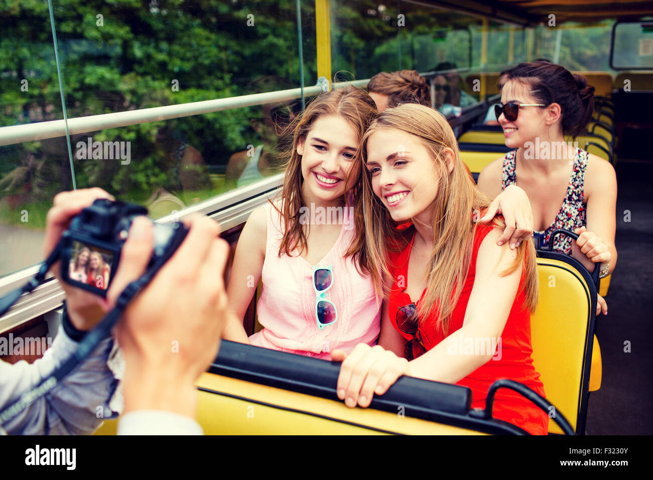 smiling friends with camera traveling by tour bus Stock Photo - Alamy
