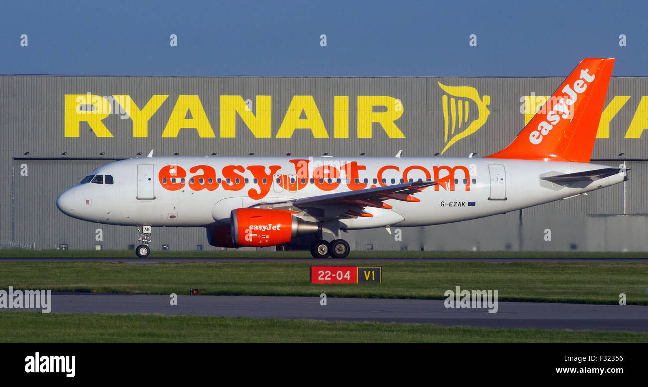 EasyJet plane G-EZAK, Airbus A319-111 passes the Ryanair hangar by the ...