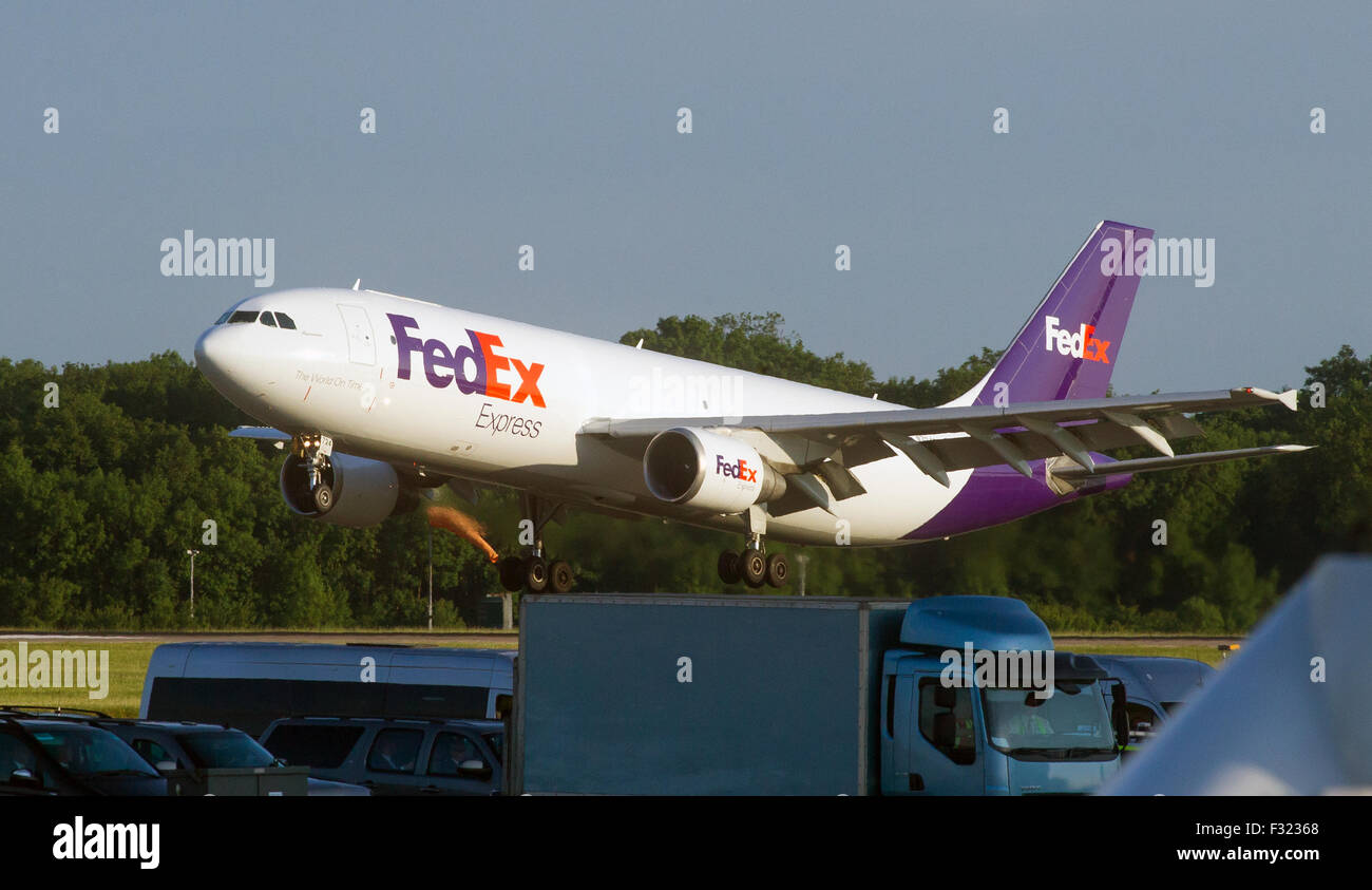 A FedEx cargo plane lands on the Runway at Stansted Airport Stock Photo ...