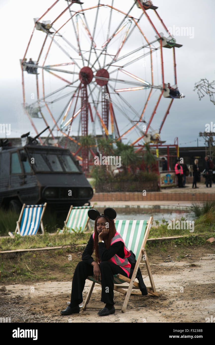 A tired and grumpy attendant. Dismaland, a bemusement park set up by ...