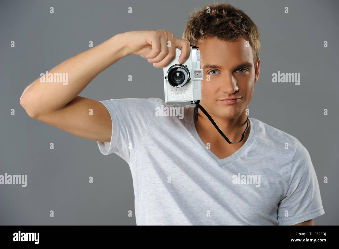 Young man with a camera Stock Photo - Alamy