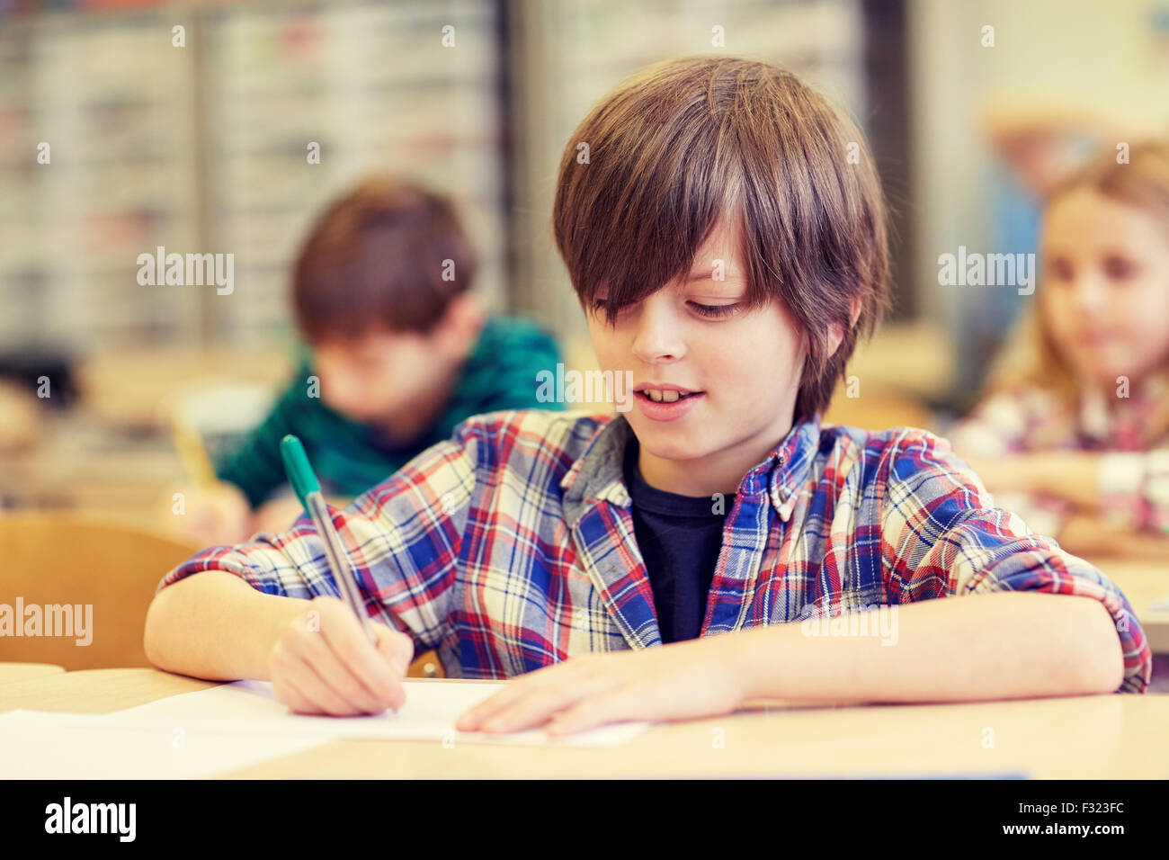 group of school kids writing test in classroom Stock Photo - Alamy