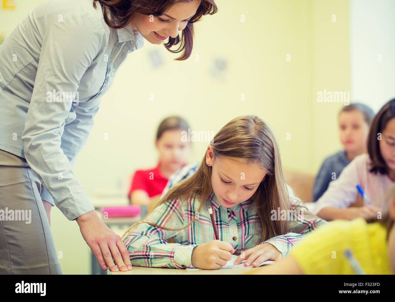 group of school kids writing test in classroom Stock Photo - Alamy