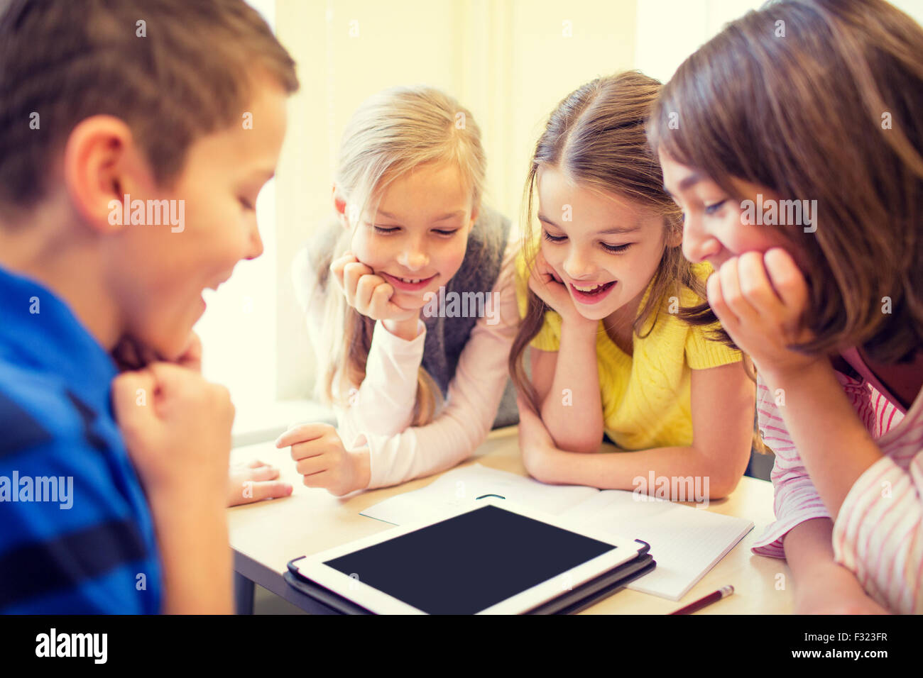 group of school kids with tablet pc in classroom Stock Photo - Alamy