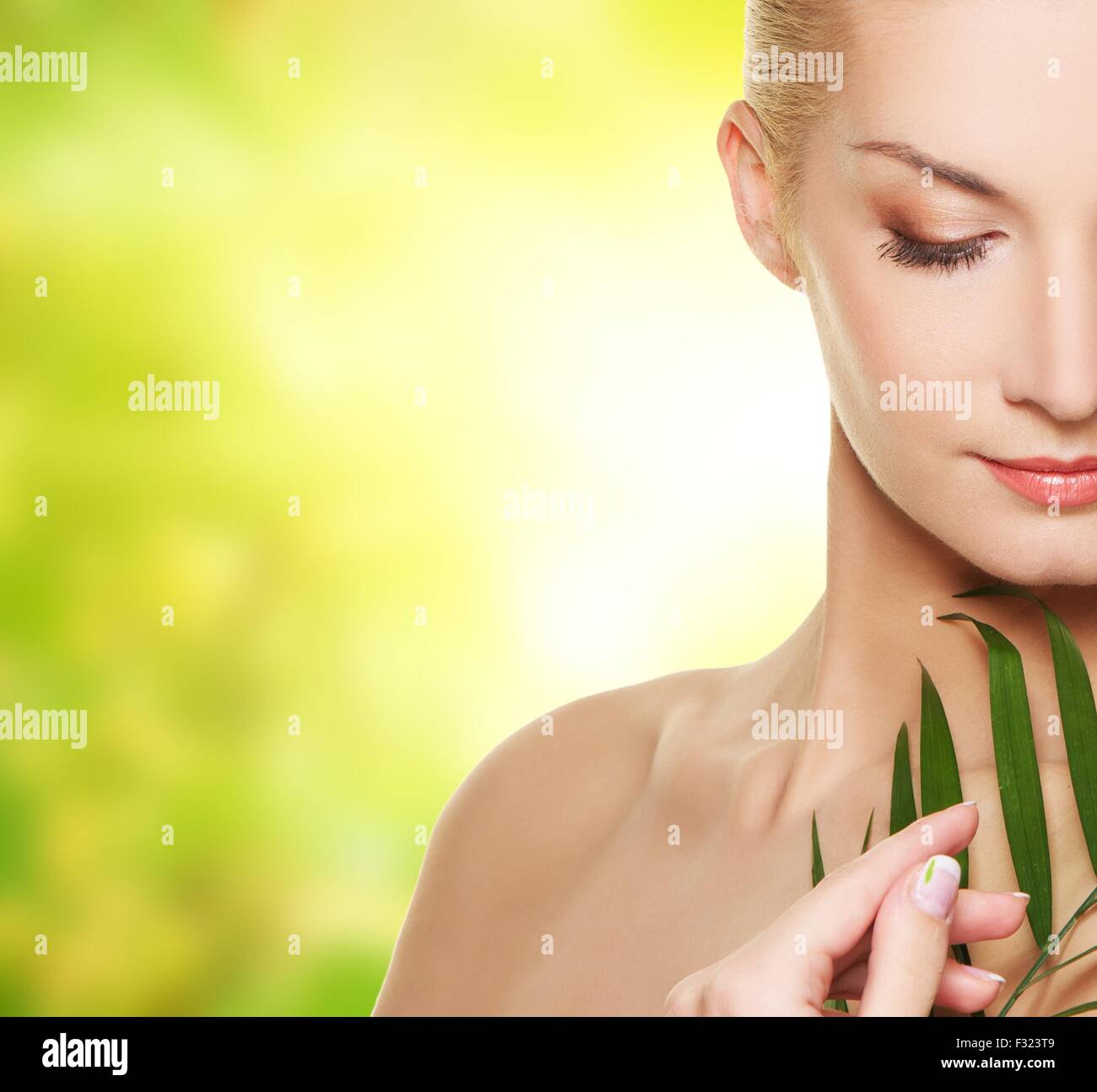 Close-up of a woman face with green plant Stock Photo - Alamy