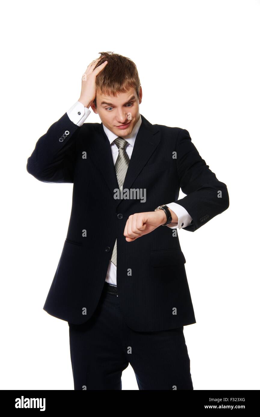 Confused businessman looking at watch Stock Photo - Alamy