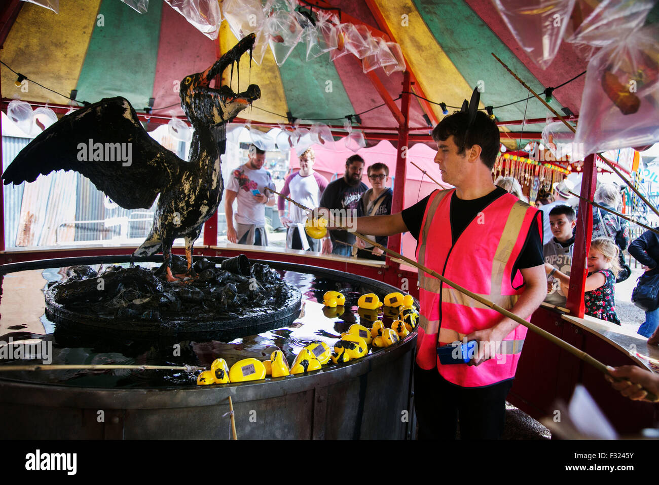 'Pluck a duck from the muck' stall. A stall with an oil covered pelican ...