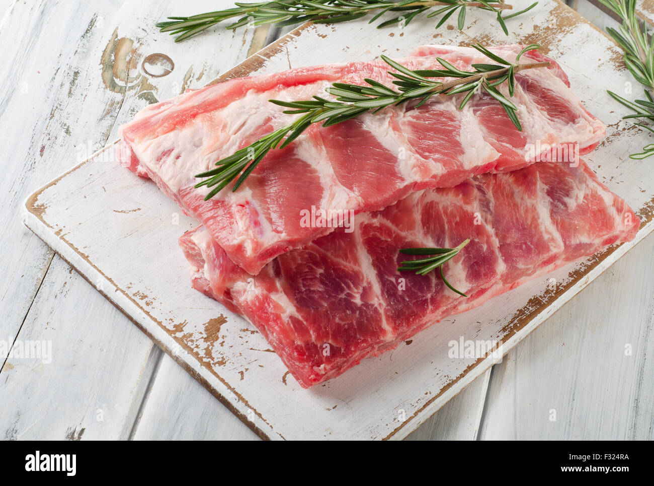 Raw ribs with a rosemary. Top view Stock Photo - Alamy
