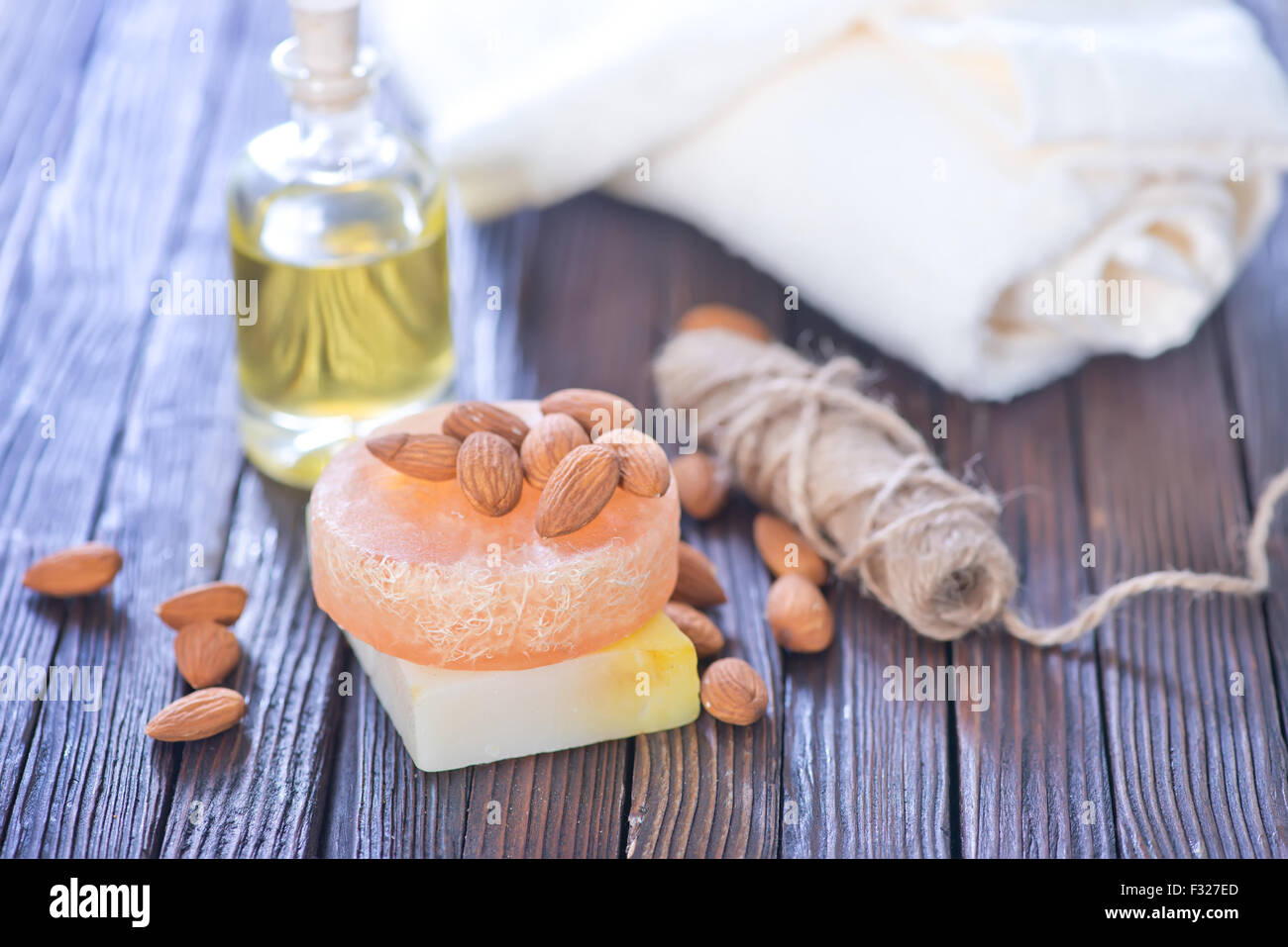almond soap and oil on the wooden table Stock Photo - Alamy