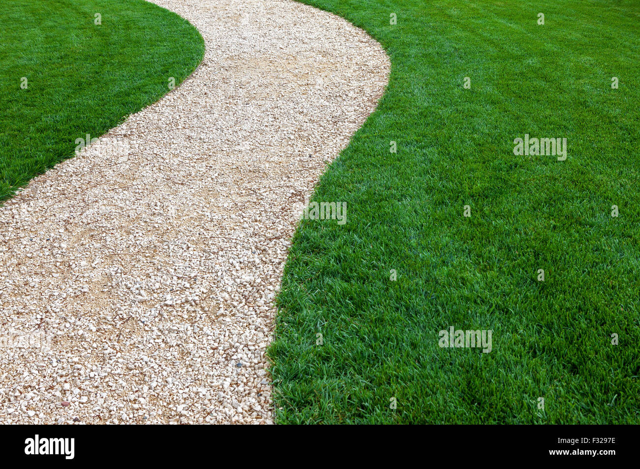 Curved garden path with fresh green cultivated lawn Stock Photo - Alamy