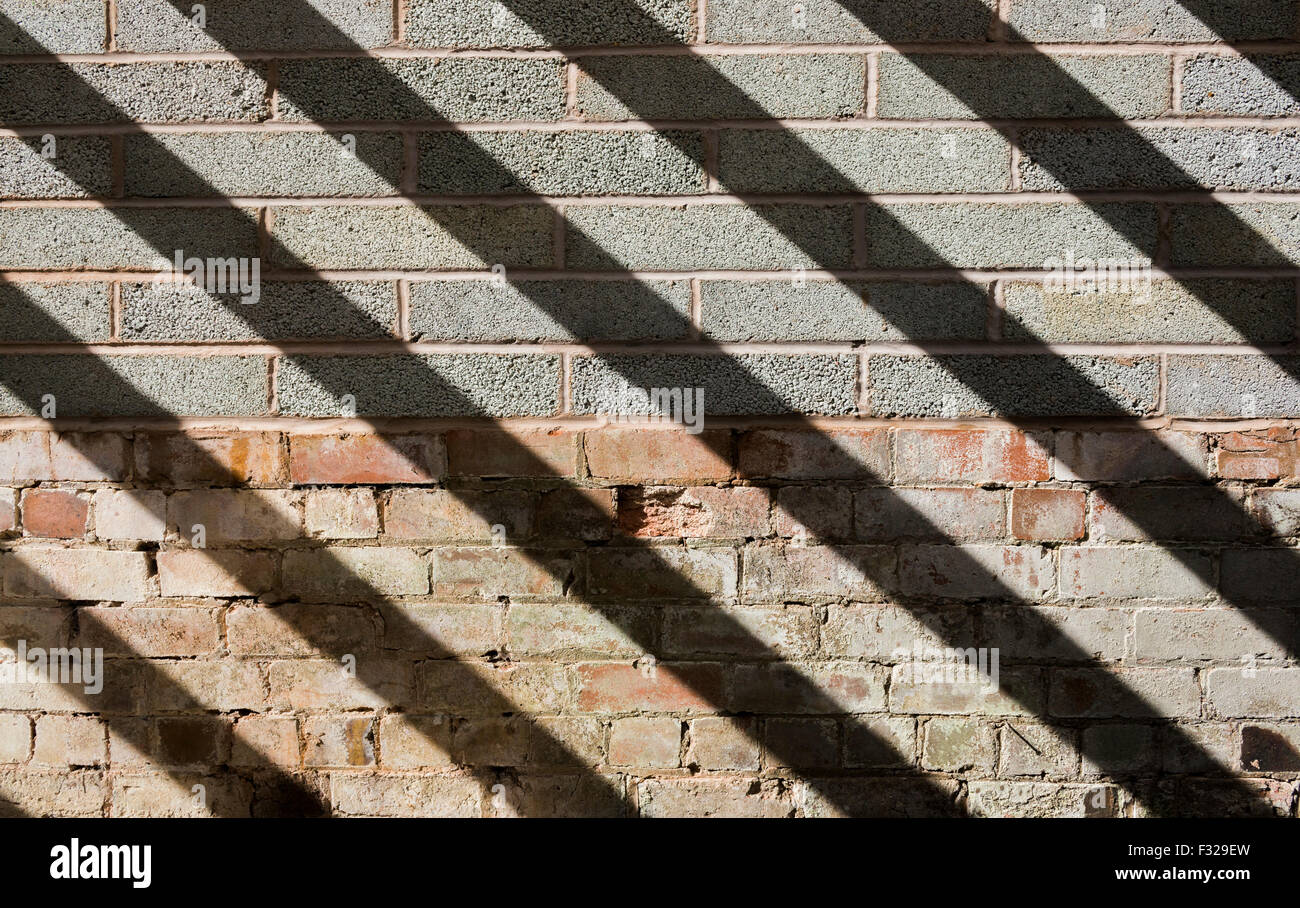 Shadows of a timber roof truss on a block wall Stock Photo - Alamy