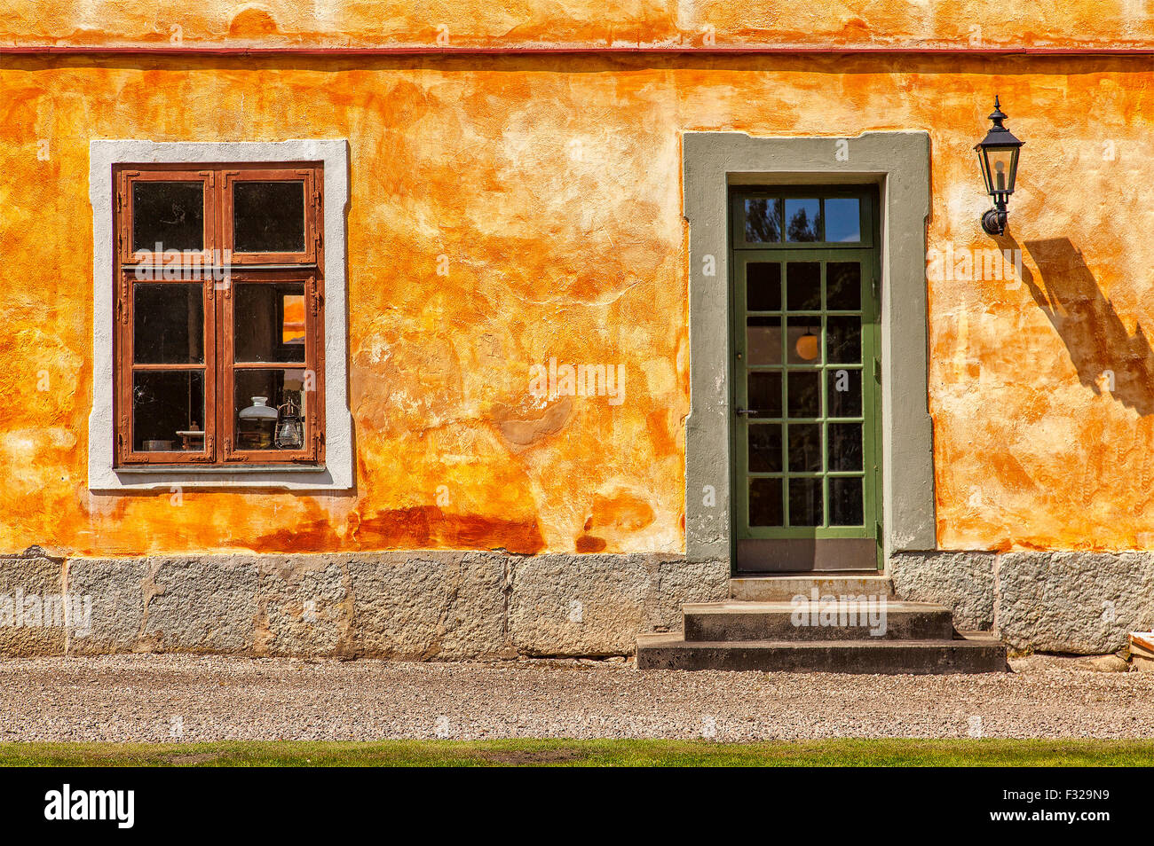 Image of a bright orange painted building Stock Photo - Alamy