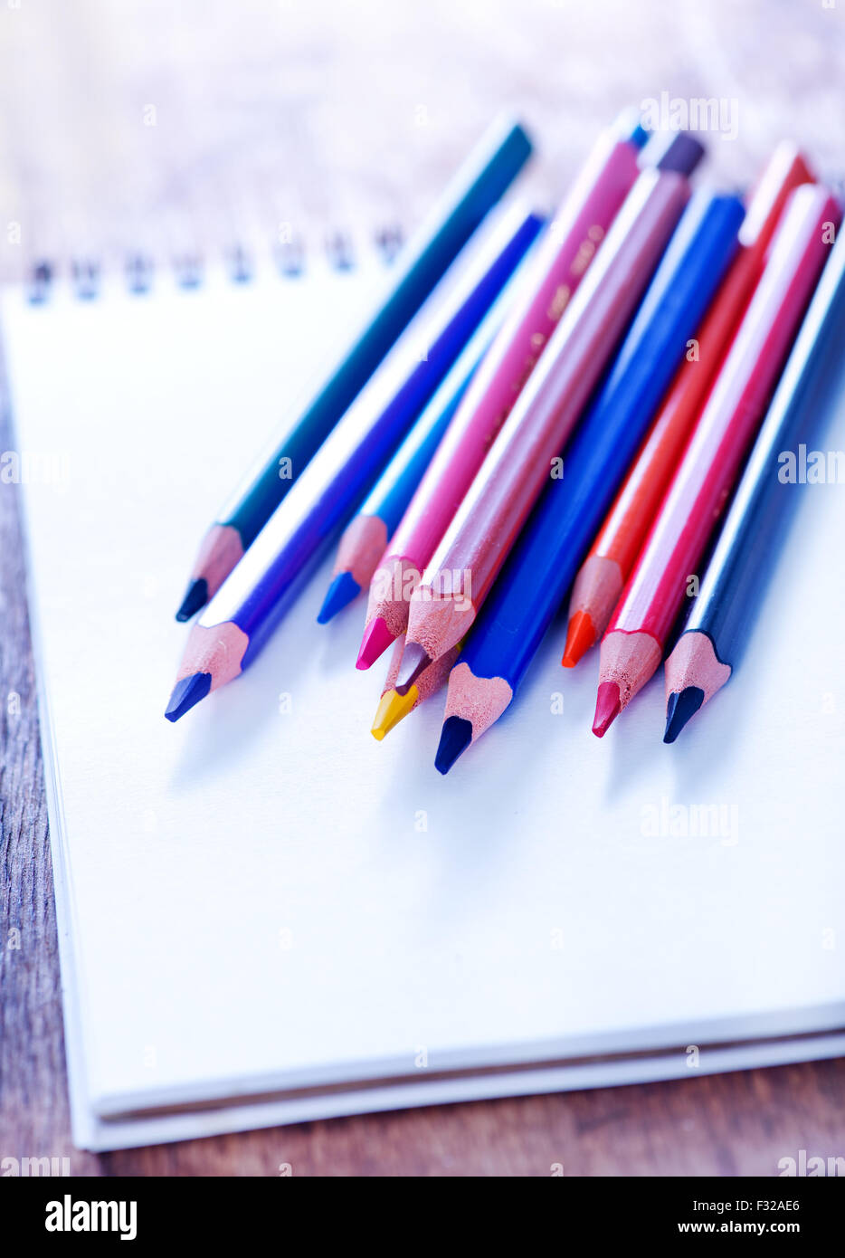color pencils and note on the wooden table Stock Photo - Alamy