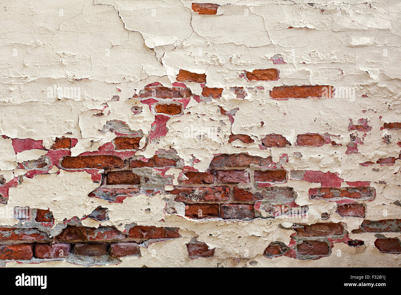 Image of an old brick wall with crumbling white plaster Stock Photo - Alamy