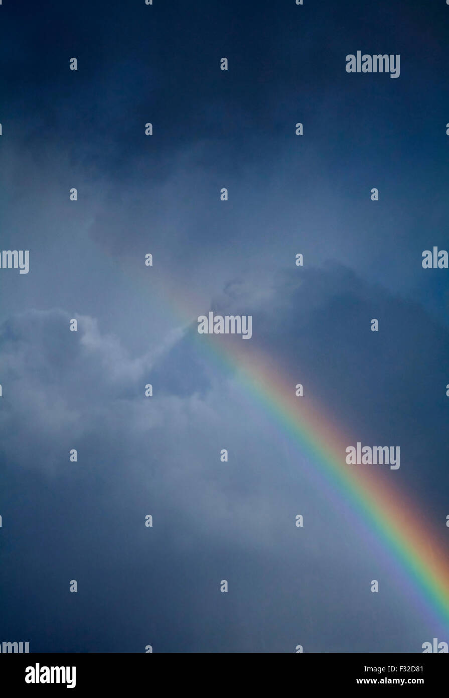 Rainbow against dark clouds hi-res stock photography and images - Alamy