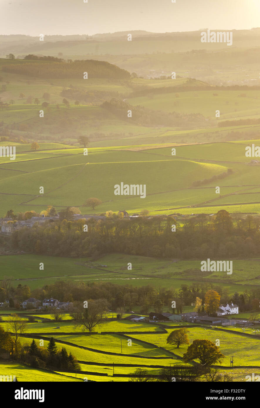 Evening sunlight illuminating fields in rural landscape, near Baslow ...