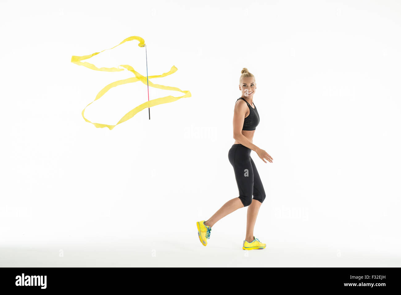 Rhythmic gymnast doing exercise with a ribbon Stock Photo - Alamy