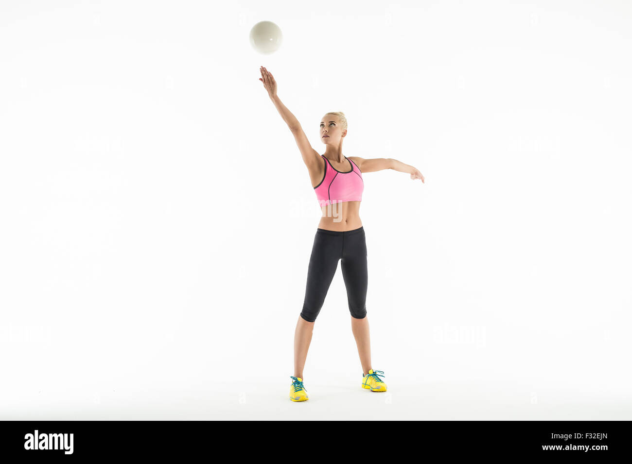 Rhythmic gymnast doing exercise with ball in studio Stock Photo - Alamy