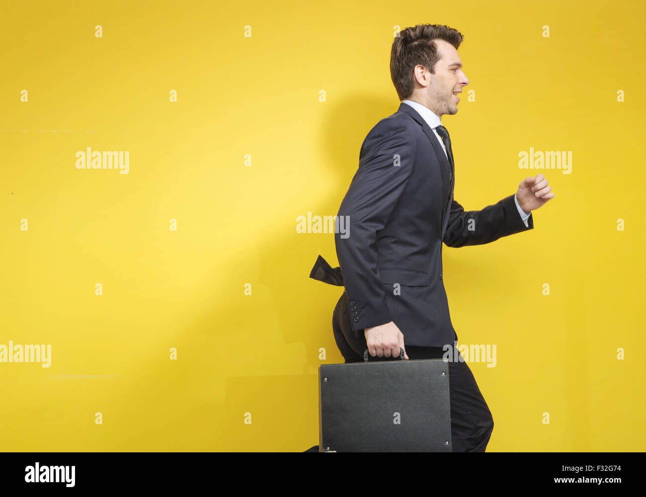 Succesful businessman with the black suitcase Stock Photo - Alamy
