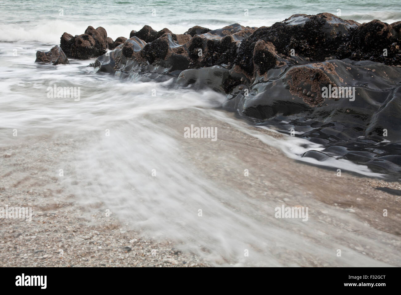 Sea washing over rocks Stock Photo - Alamy