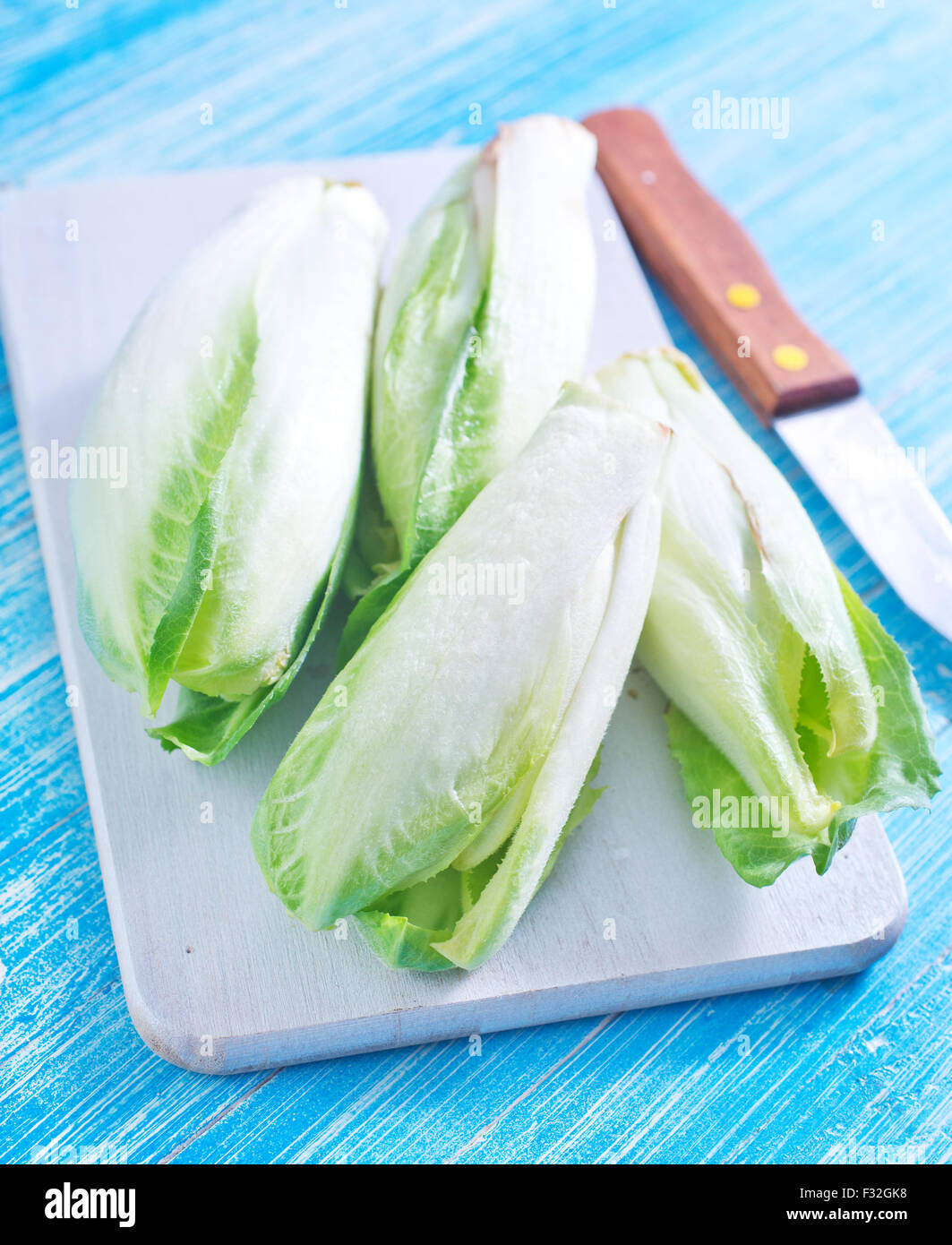 chicory on board and on a table Stock Photo - Alamy