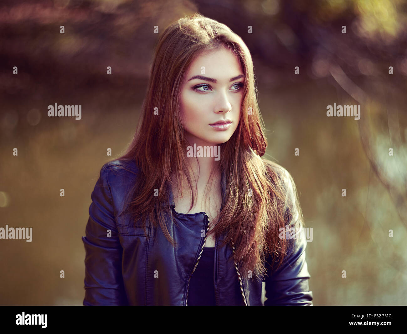 Portrait of young beautiful woman in leather jacket. Fashion photo ...
