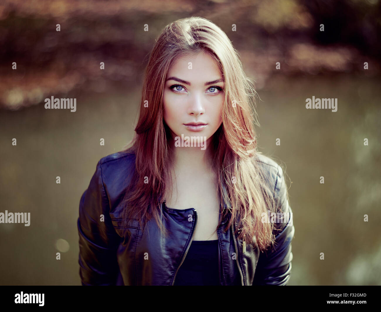 Portrait of young beautiful woman in leather jacket. Fashion photo ...