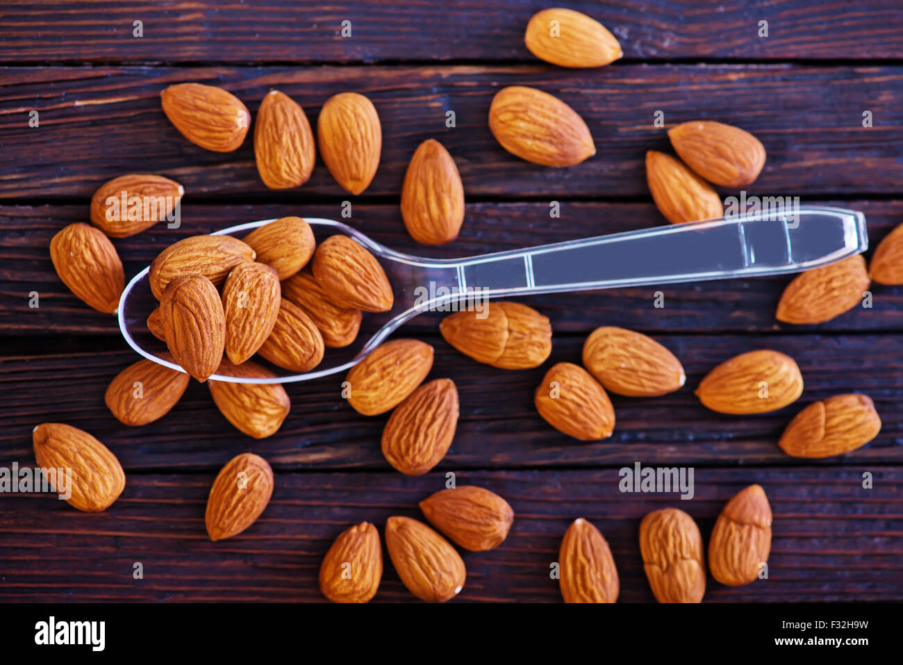 dry almond in spoon and on a table Stock Photo - Alamy