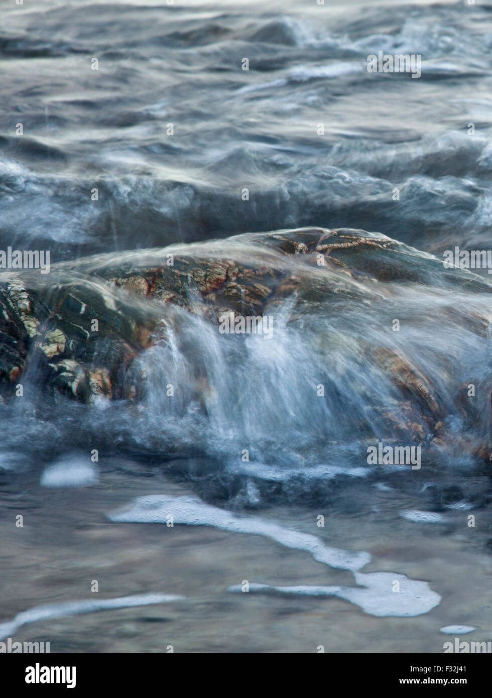 Sea washing over rocks Stock Photo - Alamy