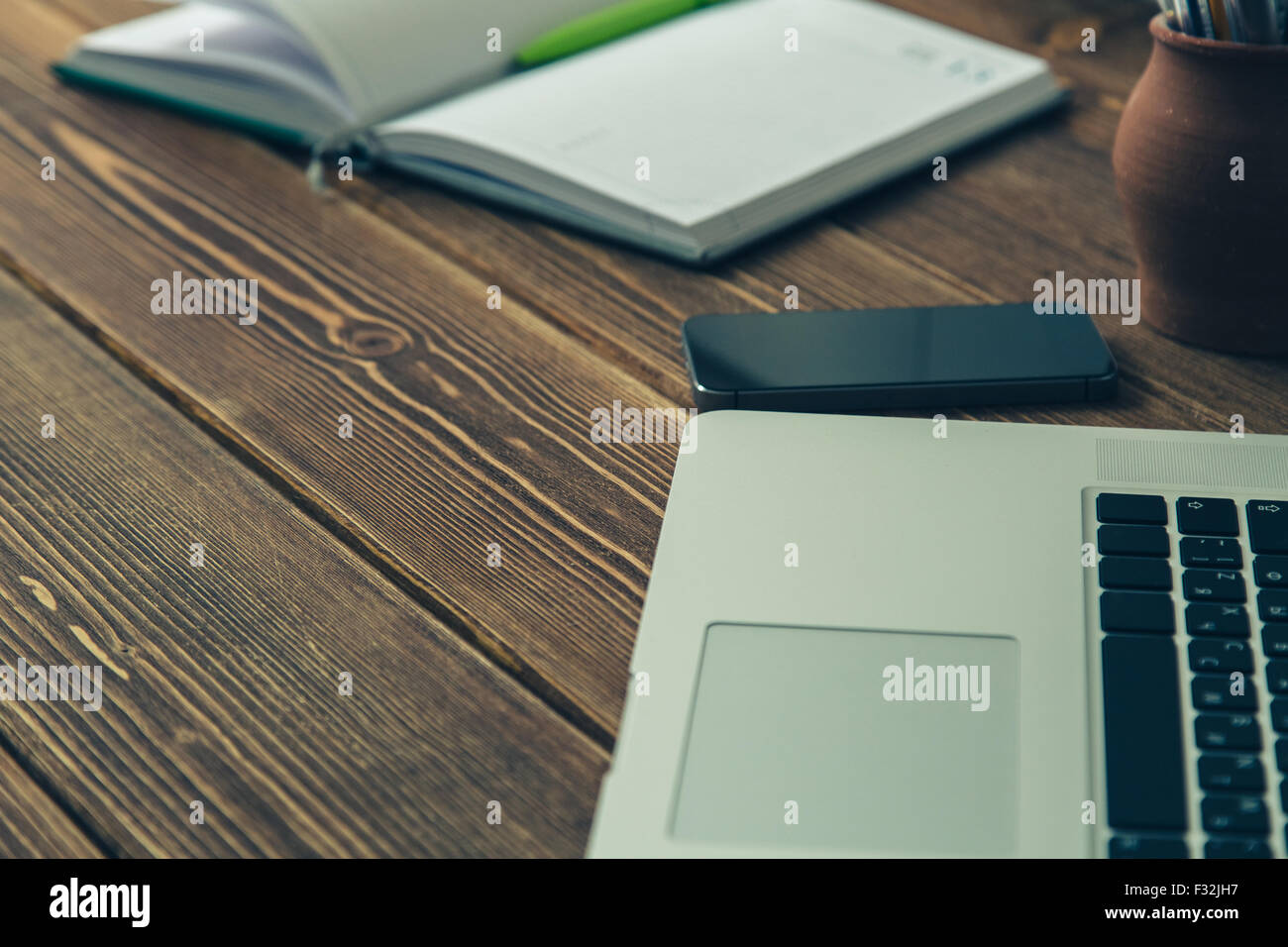 Laptop and diary on the desk Stock Photo - Alamy