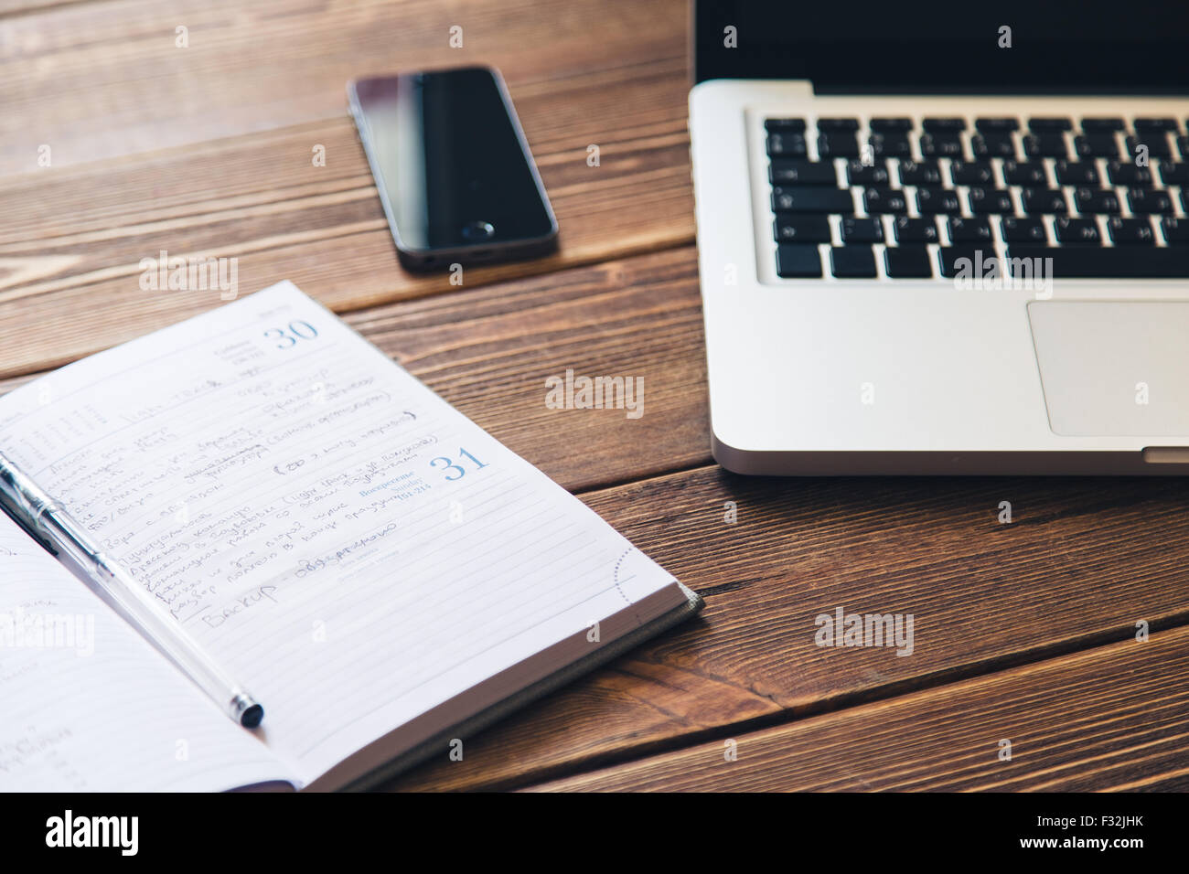 Laptop and diary on the desk Stock Photo - Alamy