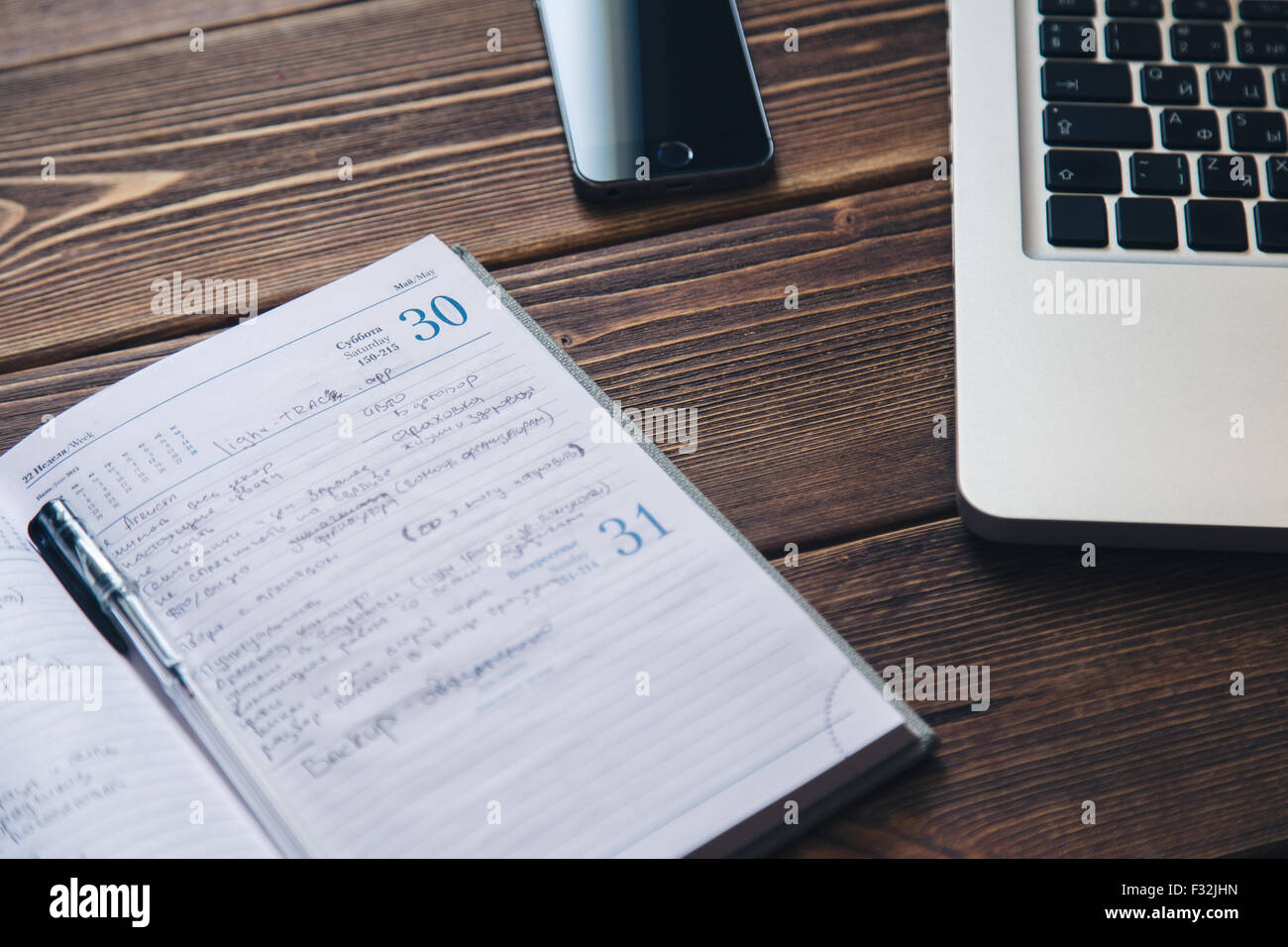 Laptop and diary on the desk Stock Photo - Alamy
