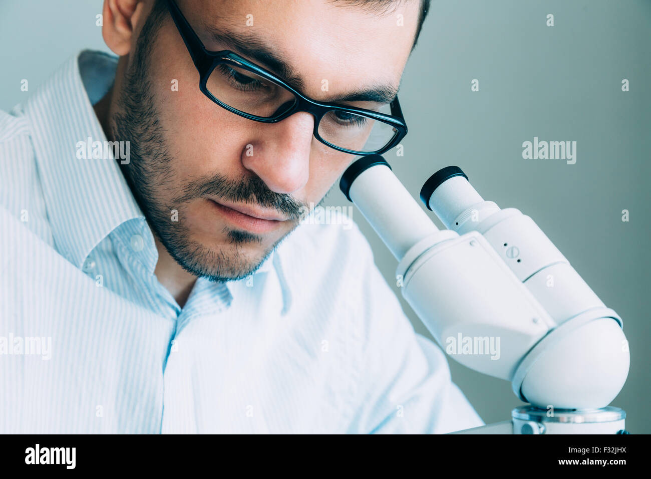 Person viewing through microscope hi-res stock photography and images ...
