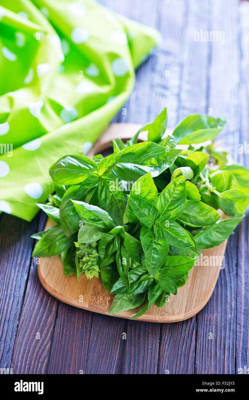 fresh basil on board and on a table Stock Photo - Alamy