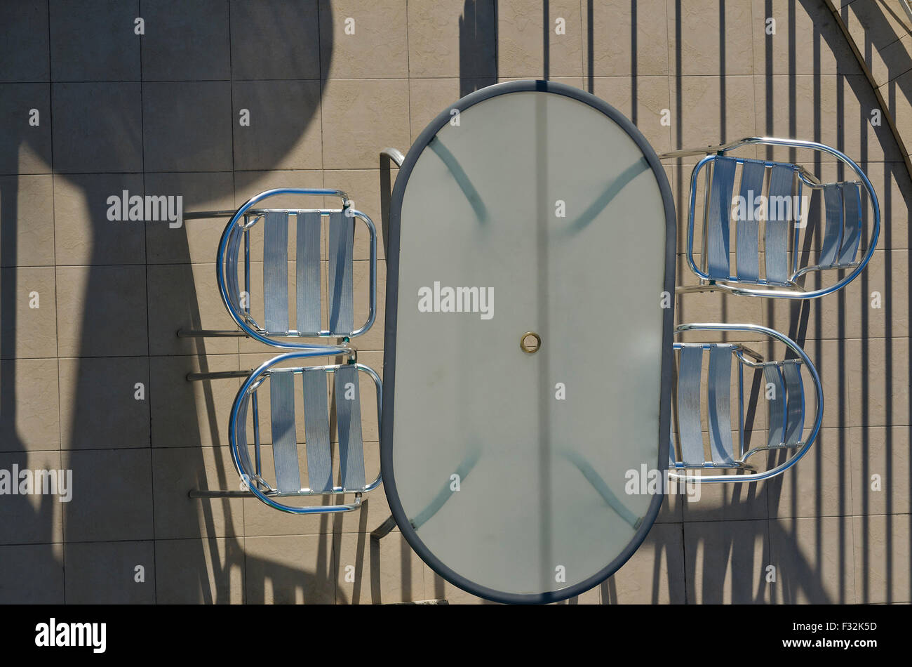 Sunny table and chairs, high angle view Stock Photo - Alamy