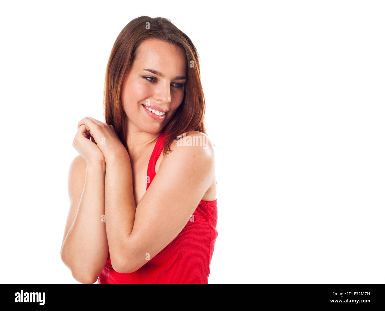 Nice young woman looking something down and smiling, isolated on white ...