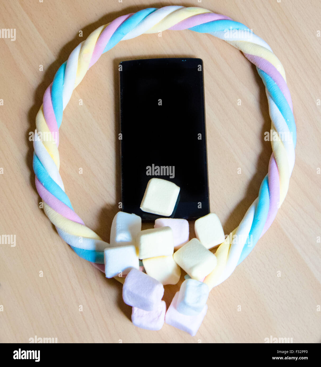 Mobile phone with colored marshmallows candies Stock Photo - Alamy