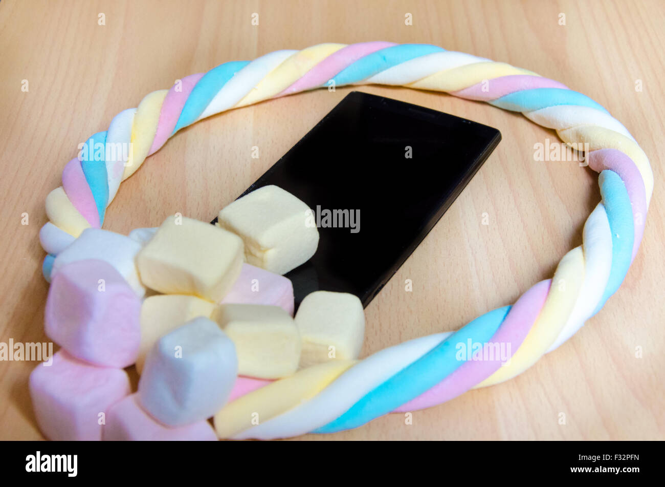 Mobile phone with colored marshmallows candies Stock Photo - Alamy