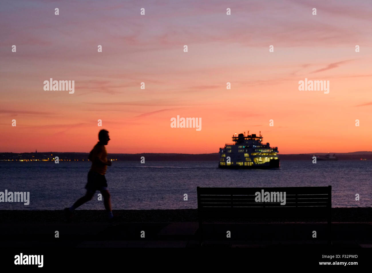 man jogging during a gorgeous sunset after a beautiful sunny day at ...