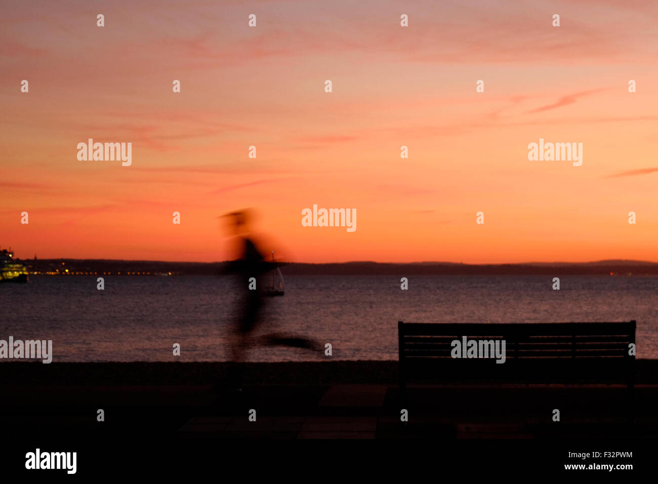 man jogging during a gorgeous sunset after a beautiful sunny day at ...