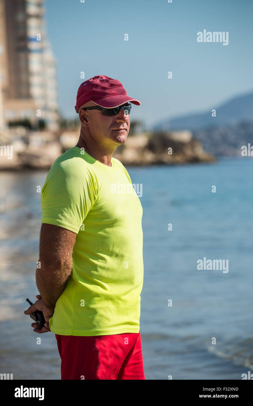 Lifeguard standing on the shore of a beach resort Stock Photo - Alamy